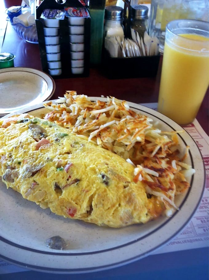 Behold the omelet that requires its own zip code! Golden perfection alongside hash browns so crispy they deserve their own fan club.