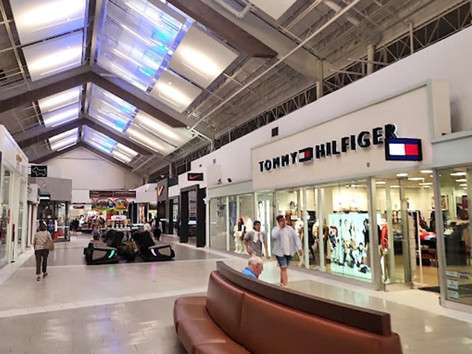 Tommy Hilfiger's gleaming storefront beckons like a retail lighthouse. That leather bench isn't just seating&mdash;it's a strategic resting spot for the shopping-weary.