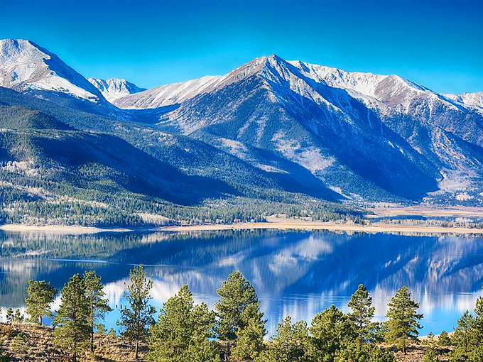Twin Lakes reflects the surrounding mountains with such perfect clarity, it's like Mother Nature checking her makeup in a mirror.