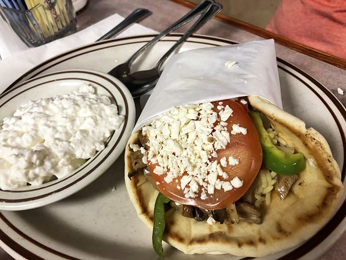 A veggie gyro that could convert carnivores, with feta sprinkled like confetti at a Greek celebration. The tzatziki side? Pure creamy genius.