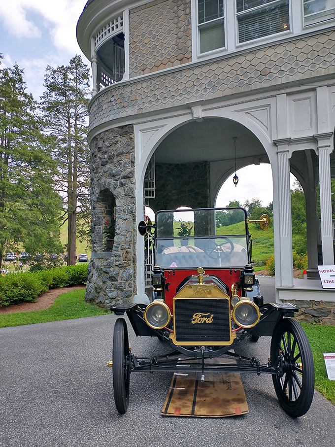 This crimson Model T isn't just parked&mdash;it's posing, showing off its brass fittings like jewelry against the mansion's stone backdrop.