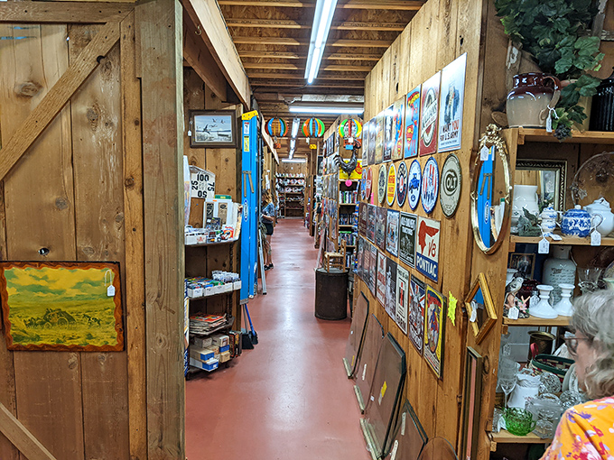 Wooden walls become galleries of Americana, where vintage signs create a time-travel corridor through decades of advertising art and roadside nostalgia.