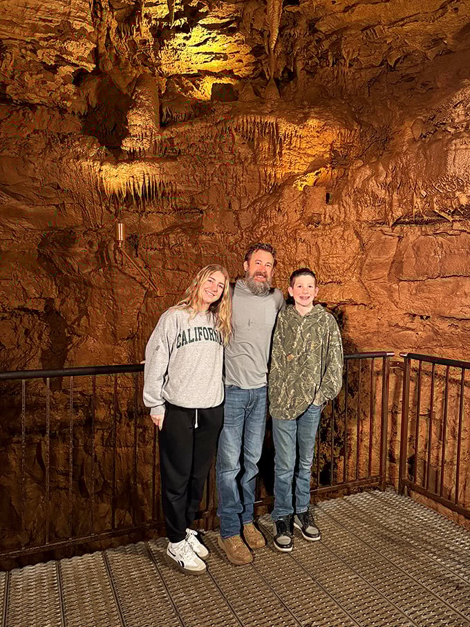 Happy explorers pausing for a moment of wonder beneath stalactites that have been growing since the Roman Empire was just getting started.