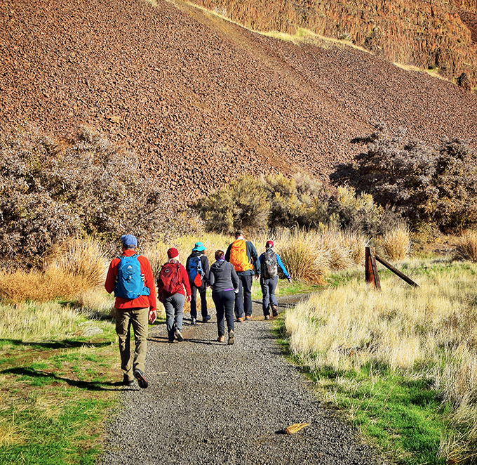 Hikers follow the trail less traveled, proving sometimes the best adventures happen when you're just a speck against nature's magnificent backdrop.