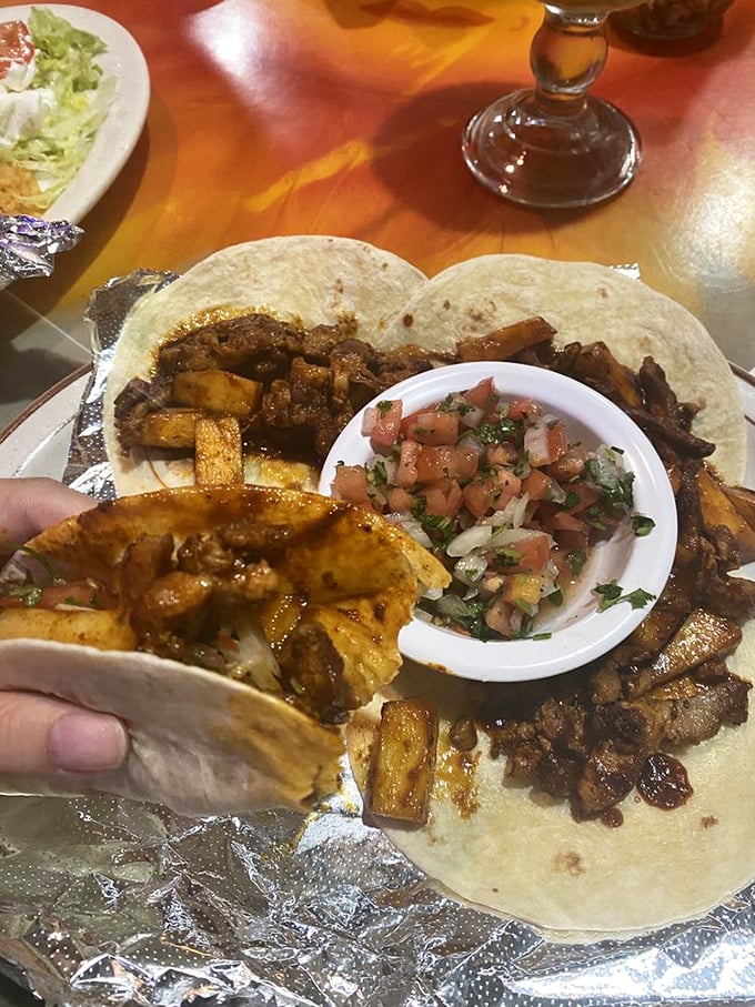 Al Pastor tacos: where pineapple-marinated pork meets fresh cilantro and onion in a hand-held fiesta that makes Tuesday night taco kits weep with inadequacy.