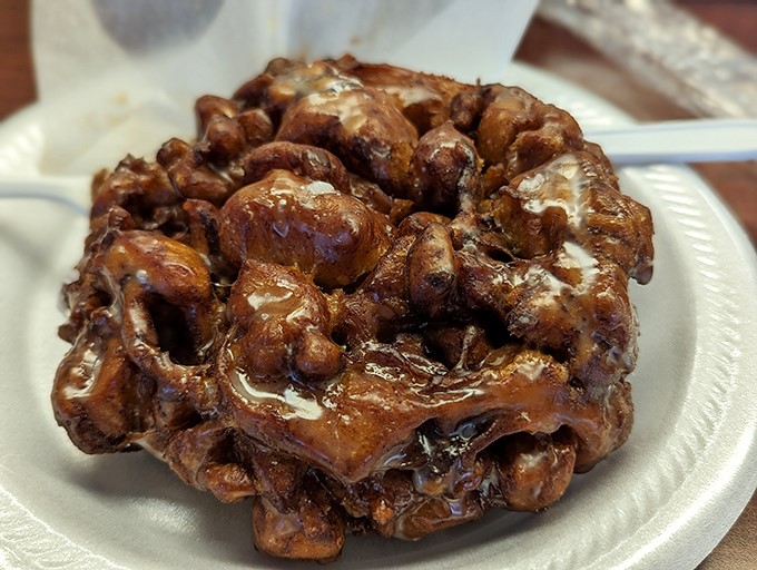 Behold the apple fritter in its natural habitat&mdash;a simple white plate that knows it's merely a stage for the star performer. Crispy edges, tender center, worth every sticky finger.