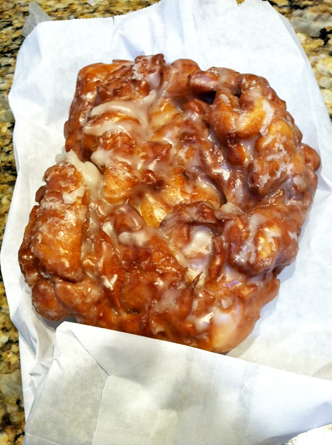 This apple fritter isn't just a donut - it's an architectural marvel of crispy, glazed peaks and valleys hiding pockets of cinnamon-apple bliss. 