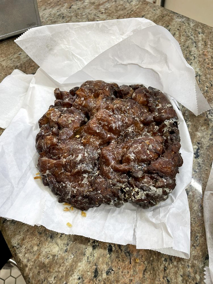 Behold the apple fritter in its natural habitat&mdash;a rugged landscape of golden-brown peaks and valleys glistening with glaze that practically demands a moment of respectful silence.