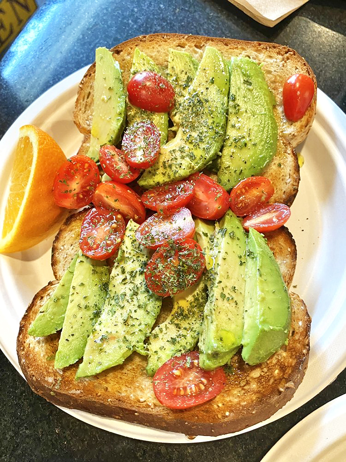 Avocado toast that actually deserves its Instagram fame—perfectly ripe slices, cherry tomatoes, and just the right sprinkle of herbs.