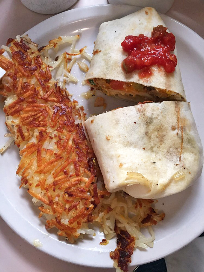 Breakfast burritos that could feed a small nation, paired with hash browns so perfectly crispy they deserve their own fan club. This is morning fuel done right.