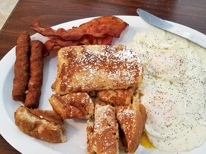 Golden French toast dusted with powdered sugar, crispy bacon, and eggs cooked just right. This breakfast trinity isn't just a meal&mdash;it's morning salvation.