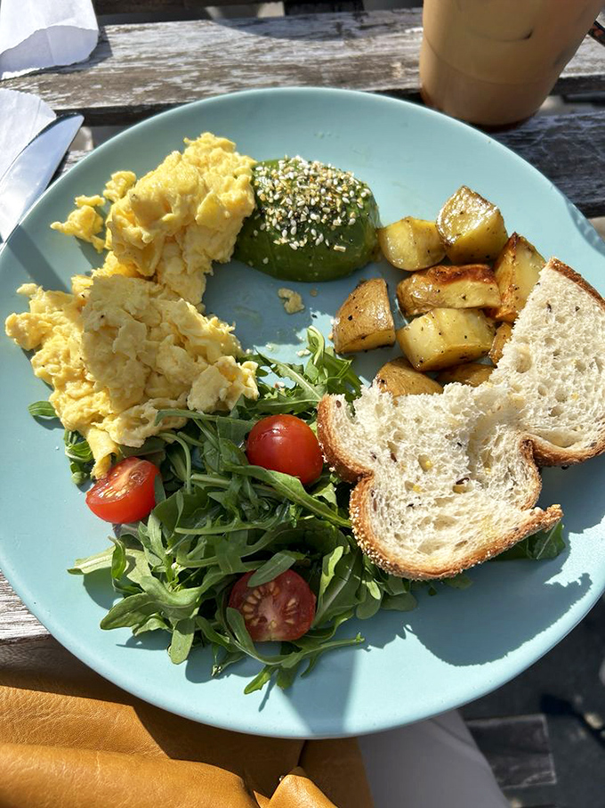Breakfast alchemy at its finest: perfectly scrambled eggs, avocado that California would envy, and potatoes crisped to golden perfection.