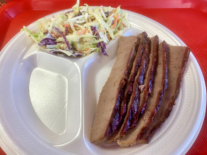 Brisket sliced thin enough to read through, with that telltale smoke ring that says, "I wasn't rushed." The coleslaw stands by, ready for its supporting role.