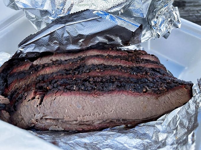 Behold the holy grail of Texas-meets-Carolina barbecue: brisket with that perfect pink smoke ring and bark that makes meat lovers weak at the knees.