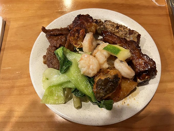 A seafood lover's fantasy realized: crab legs, clams, and shrimp coexisting on a single plate like the most delicious neighborhood block party ever assembled.