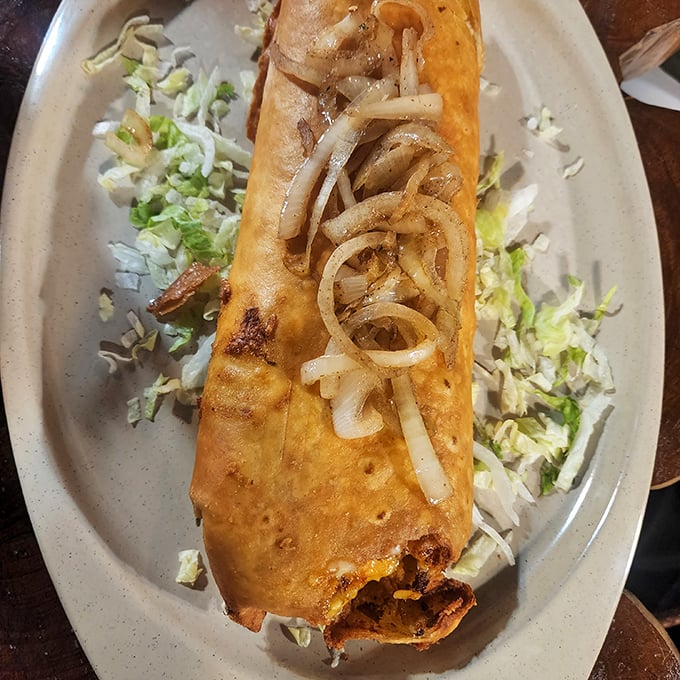 Behold the burrito in its natural habitat &ndash; golden-brown, stuffed with goodness, and topped with those perfect caramelized onions that dreams are made of.