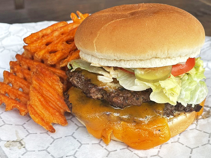 This isn't just a cheeseburger; it's edible architecture where every layer plays its part in a symphony of flavor.