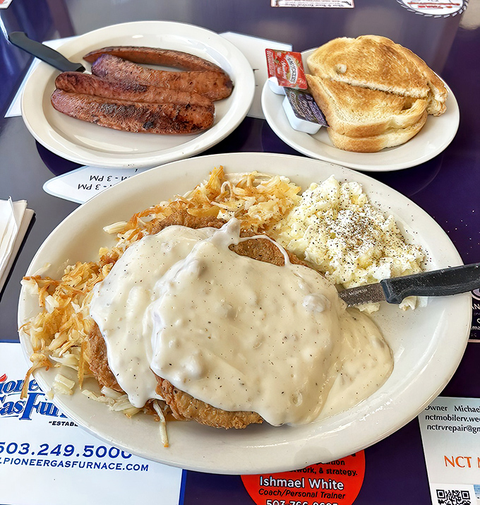 Behold the chicken fried steak in its natural habitat &ndash; swimming in gravy, flanked by golden toast and sausage links standing guard.