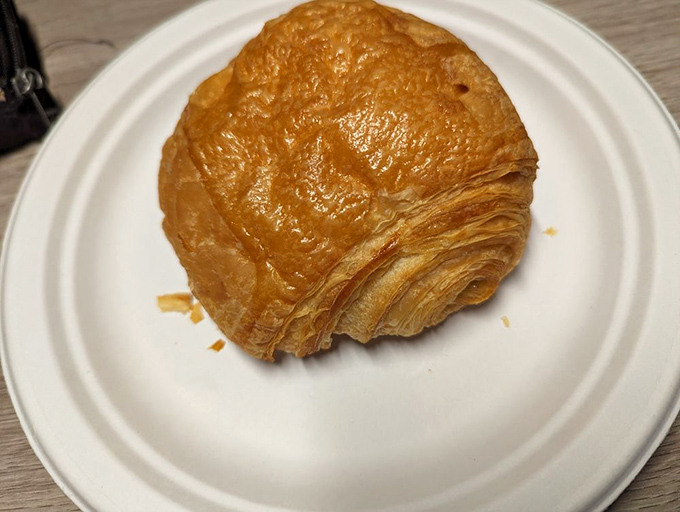 Golden, flaky, and more layers than your favorite HBO drama. This croissant doesn't just break when bitten &ndash; it shatters with buttery authority.