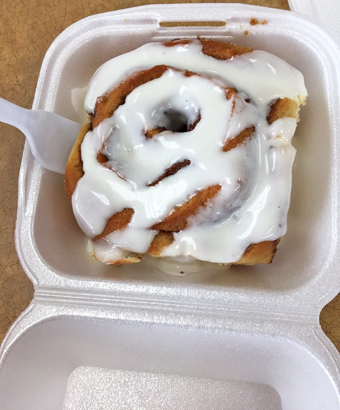 Behold, the to-go cinnamon roll in its natural habitat. This little box contains more joy than most people experience in an entire workweek.