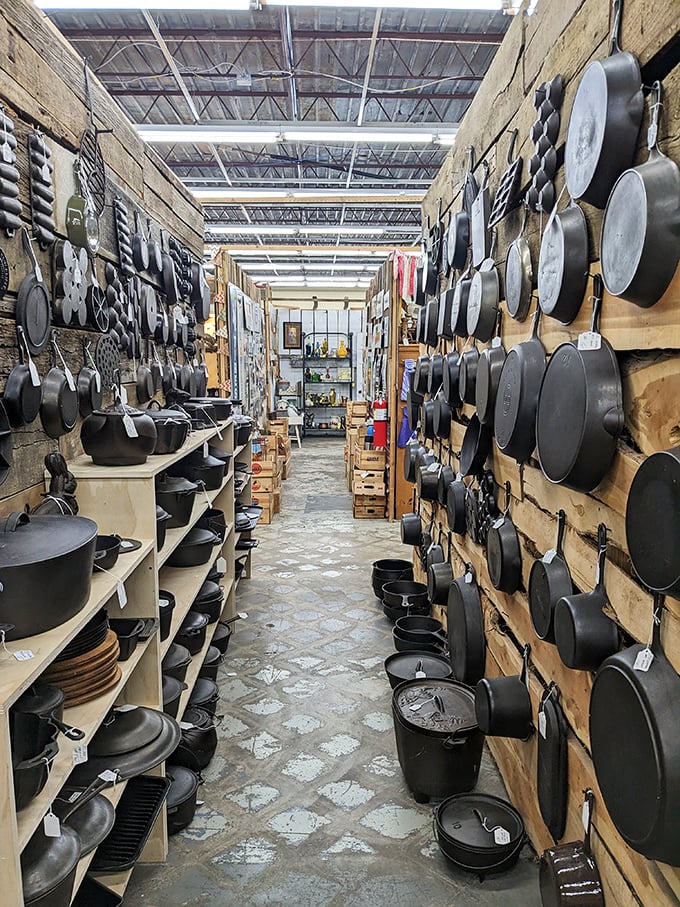 Cast iron paradise! This aisle could outfit a frontier kitchen or a modern foodie's dream home with seasoned cookware that's outlasted generations.