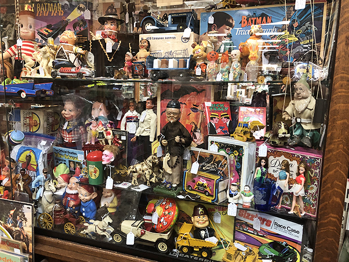 This glass case might as well be labeled "Childhood Memories Department" &ndash; where Batman meets vintage dolls in a nostalgia explosion that'll have you pointing and exclaiming.