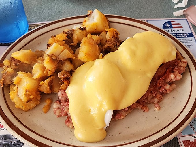 Hollandaise sauce cascading over perfectly poached eggs and corned beef hash. This plate doesn't need a filter&mdash;it needs your undivided attention.
