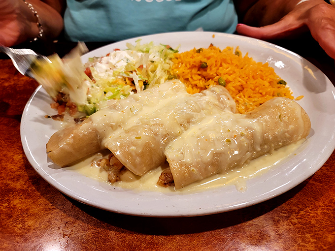 Enchiladas bathed in creamy sauce that's clearly been simmering since morning. This isn't cheese sauce&mdash;it's liquid velvet with a Mexican passport.