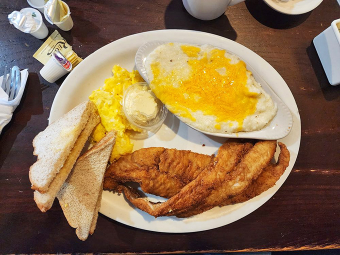 Golden-fried catfish that shatters with each bite, paired with eggs that remind you breakfast knows no time constraints.