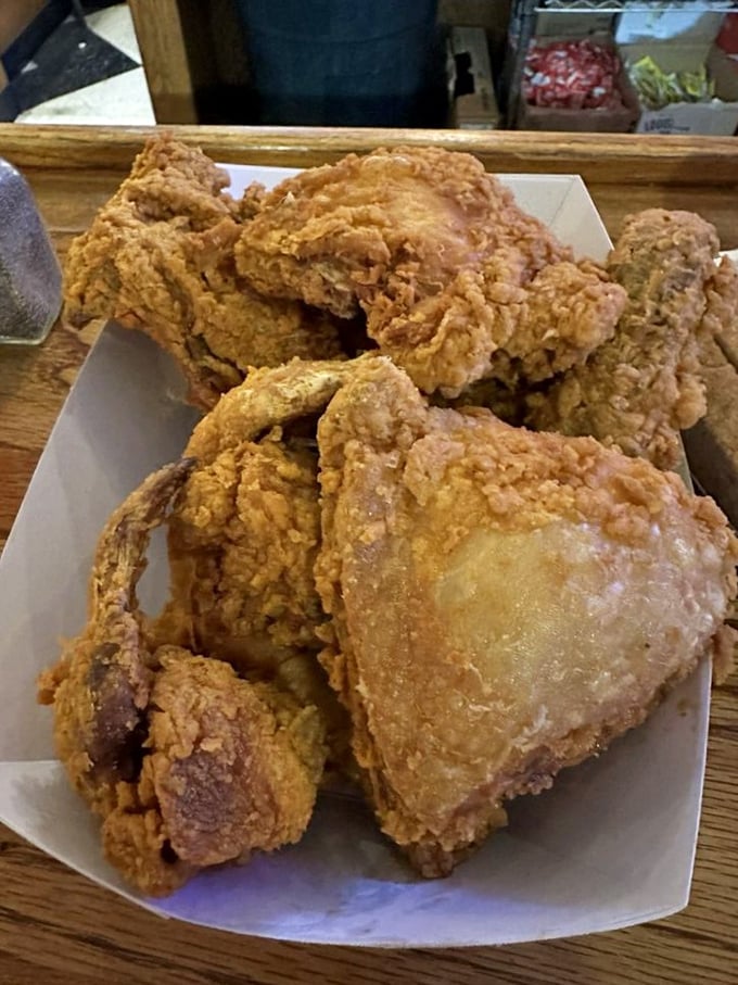 Golden-brown perfection that makes you forget your table manners. This chicken doesn't need fancy plating—the paper is just there to catch your tears of joy.