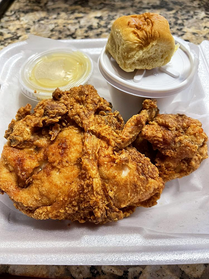 Golden-brown perfection that makes you question every other fried chicken you've ever eaten. That honey sauce and roll are not optional&mdash;they're essential companions.