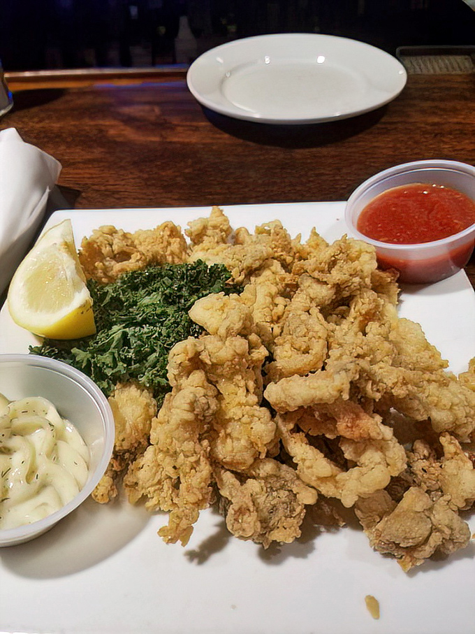 Golden-battered whole belly clams&mdash;crispy outside, tender inside&mdash;sit proudly alongside their dipping companions. The holy trinity of seafood perfection!