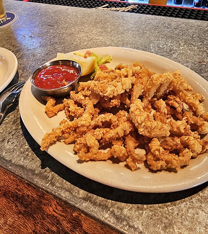 Golden-fried clam strips that crunch like autumn leaves but taste like summer vacation. These crispy morsels are what seafood dreams are made of.