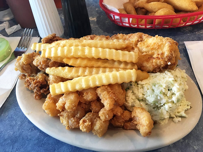 Golden-fried perfection on a plate. The crinkle-cut fries and creamy coleslaw aren't just sides&mdash;they're supporting actors in a delicious coastal drama.