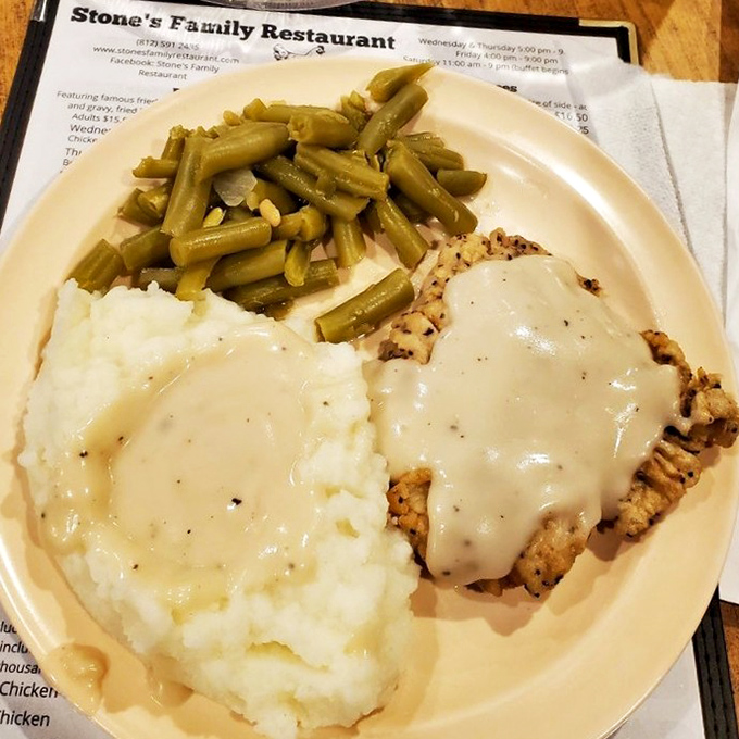 The legendary country fried steak arrives like a work of art &ndash; golden breading, creamy gravy, fluffy mashed potatoes, and green beans that grandma would approve of.