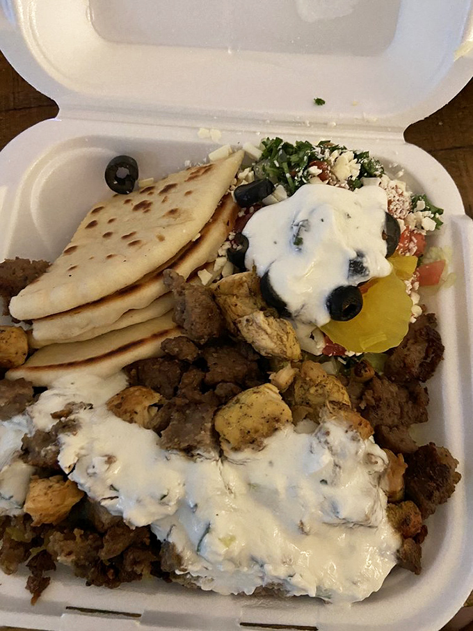 This isn't just a meal, it's a Mediterranean vacation in a takeout container. Look at that tzatziki cascading over perfectly seasoned meat!