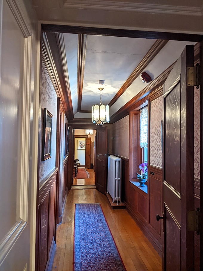 Wandering down this elegant hallway feels like stepping into a period drama, where you half-expect a butler to appear offering afternoon tea.