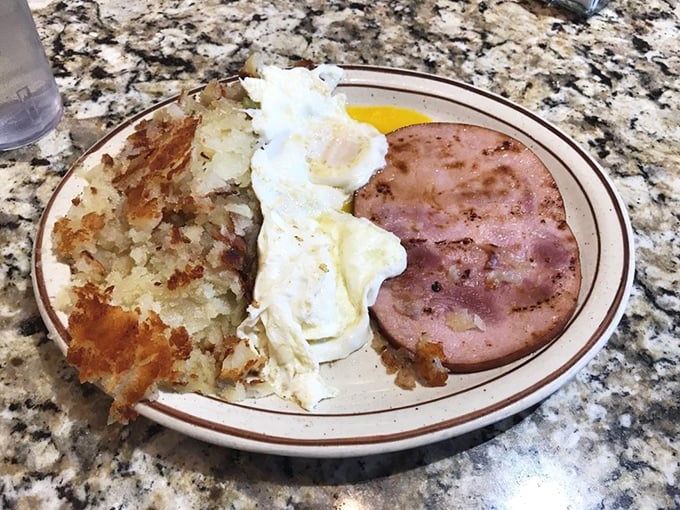 Simple perfection on a plate: crispy hash browns, eggs with personality, and ham that didn't come from a package. This is breakfast therapy.