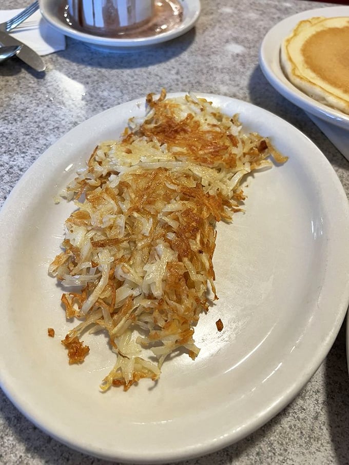 The star attraction in all its golden glory&mdash;these hash browns achieve that mythical balance of crispy exterior and tender interior that potato dreams are made of.