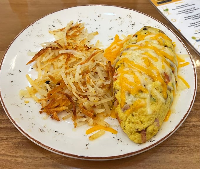 Behold the star of our show: those legendary hash browns sharing the spotlight with an omelet that's dressed for success in melted cheddar.