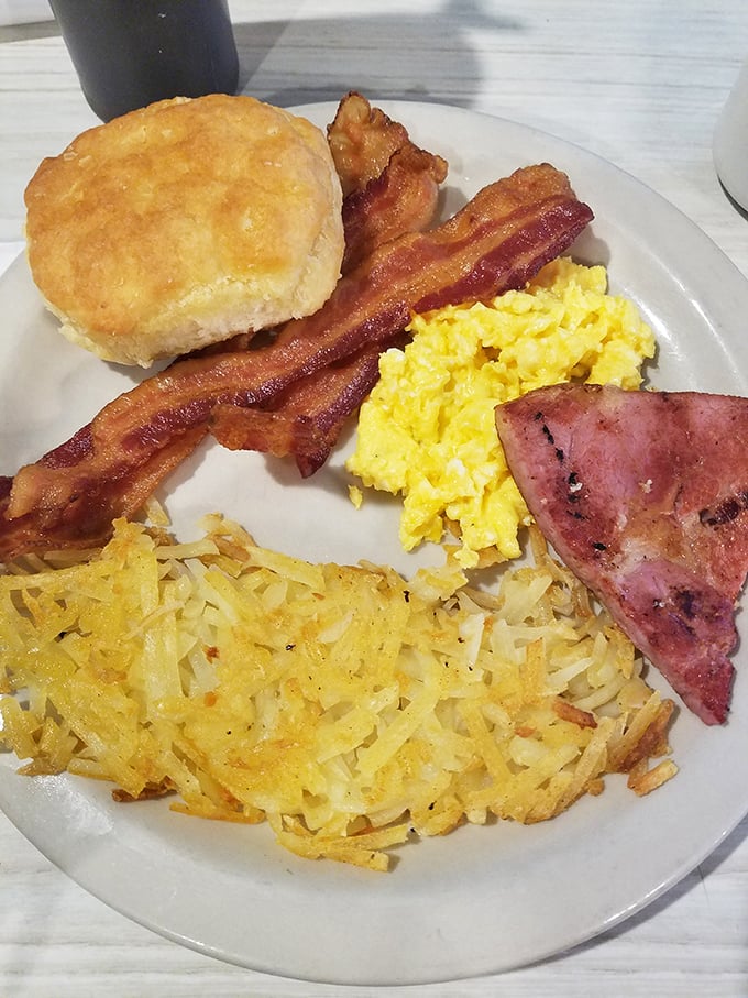 The holy trinity of breakfast perfection: those legendary hash browns, fluffy scrambled eggs, and a biscuit that would make your Southern grandma weep with pride.