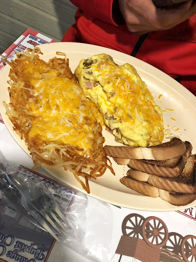 Behold the star attraction: hash browns that achieve the impossible balance of crispy exterior and tender interior, topped with melted cheese that should win awards.