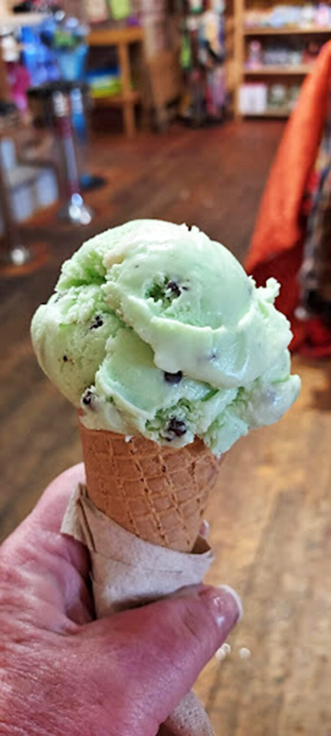 Mint ice cream studded with chocolate bits sits atop a waffle cone&mdash;the perfect companion for wandering Victor's sun-drenched streets.