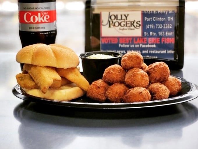 The perch sandwich in its full glory, flanked by hush puppies that deserve their own fan club. This plate says "Ohio lakeside summer" better than any postcard could.