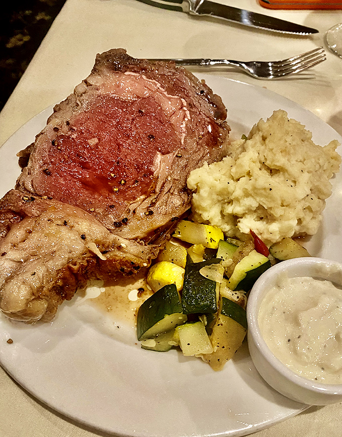 Prime rib perfection that makes vegetarians question their life choices. That perfect pink center is what beef dreams are made of.
