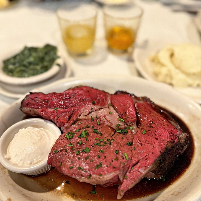 This prime rib isn't just dinner—it's a religious experience. Perfectly pink, glistening with jus, and garnished with just enough green to pretend it's balanced.