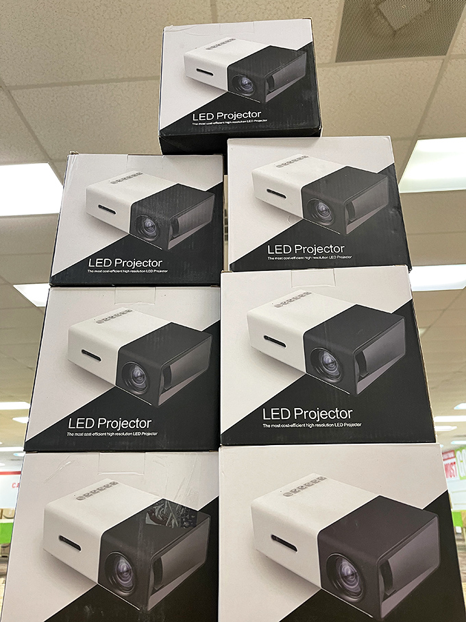 Stack of LED projectors waiting for their forever homes. Movie night just got a whole lot fancier for some lucky bin divers.