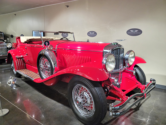 This crimson 1930s Duesenberg isn't just a car; it's wearable architecture. The Art Deco era on wheels, when automobiles were rolling sculptures.