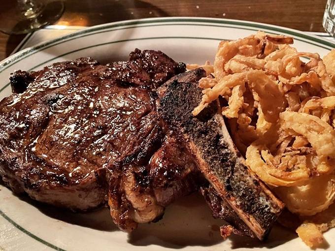 This isn't just a steak; it's a masterclass in meat preparation with those onion rings playing the perfect supporting role. Oscar-worthy performance on a plate.