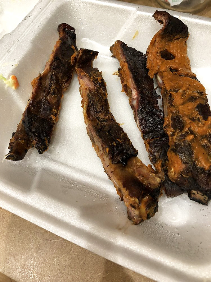These ribs showcase that perfect bark &ndash; dark, caramelized, and promising flavors that'll make you forget your own name.